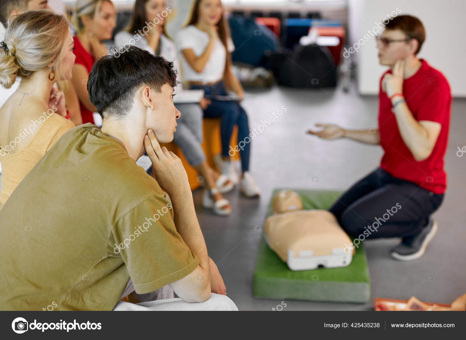 Young people learning how to safe a life sitting together on lesson ...
