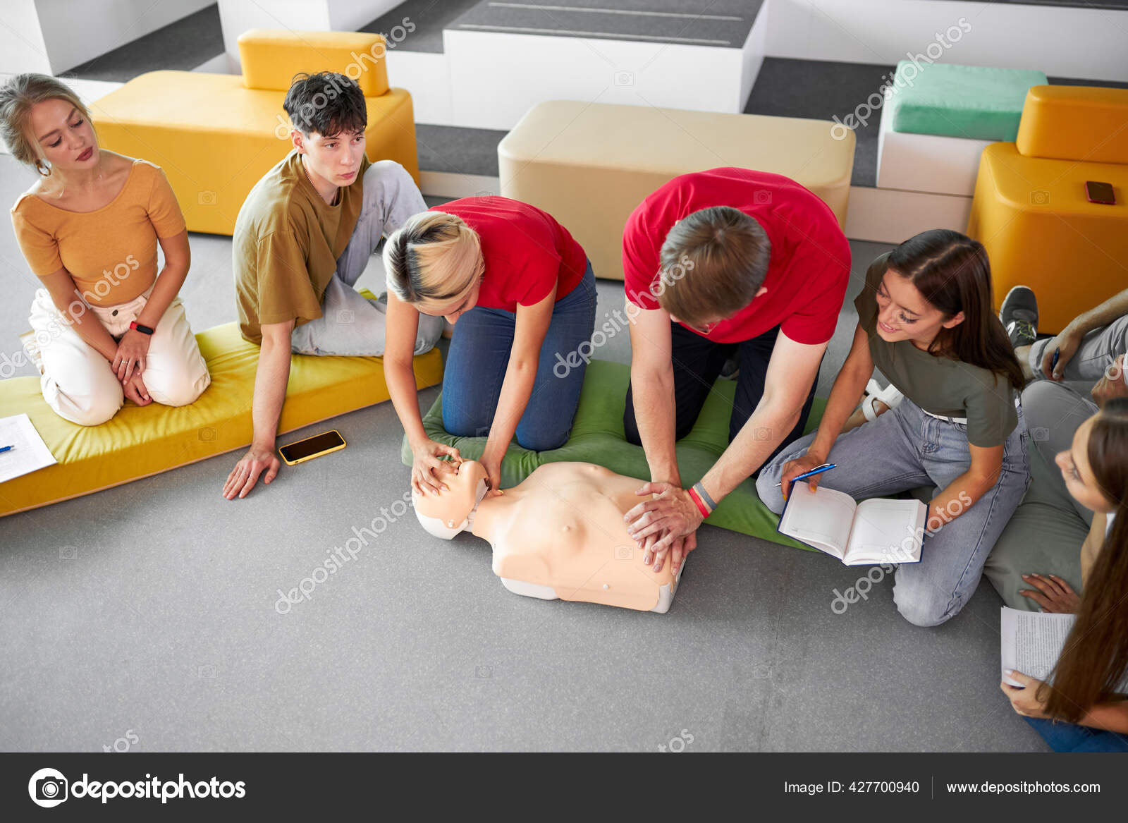 Group of diverse people practice first aid training by hand Stock Photo ...