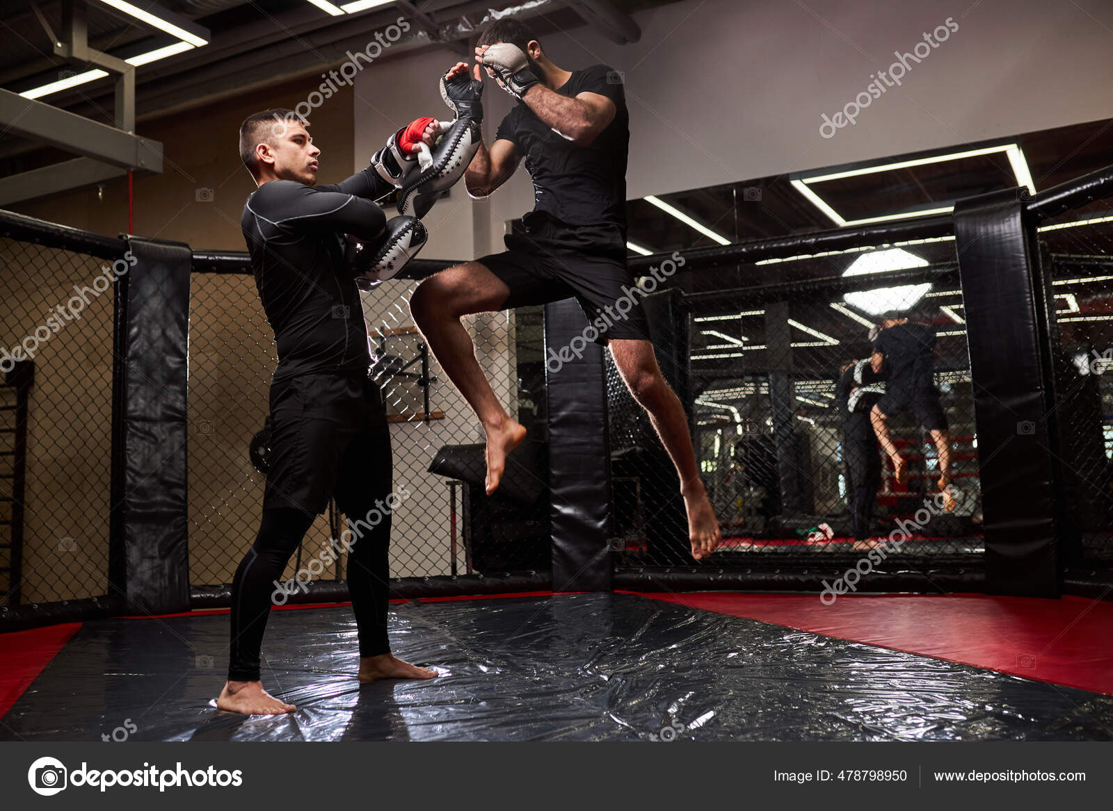 Side view on professional mma fighter teaches self-defense tricks ...