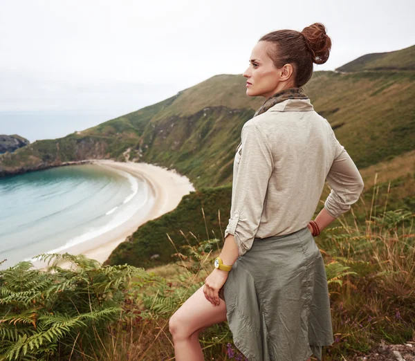 woman looking into distance in front of ocean view landscape - Stock ...