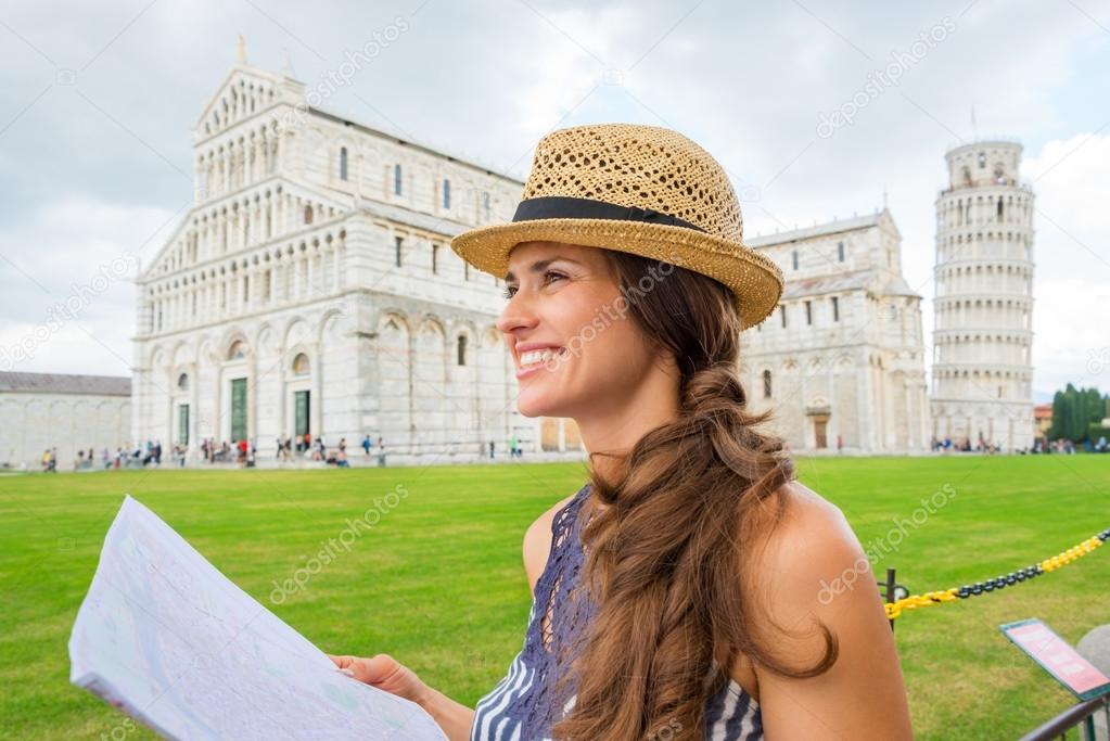 Happy female tourist in profile holding map, Piazza dei Miracoli Stock Photo by ©CITAlliance ...