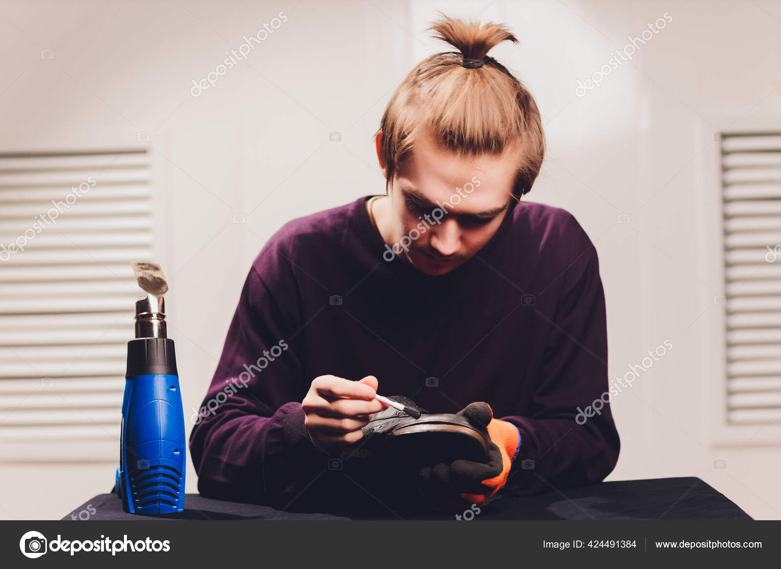 A shoemaker cuts the sole of a Shoe with a shoemakers automatic cutter ...