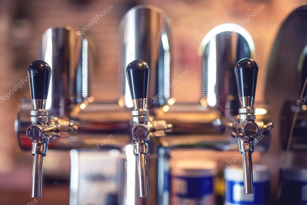 Beer tap at restaurant, bar or pub. Close-up details of beer draft taps ...