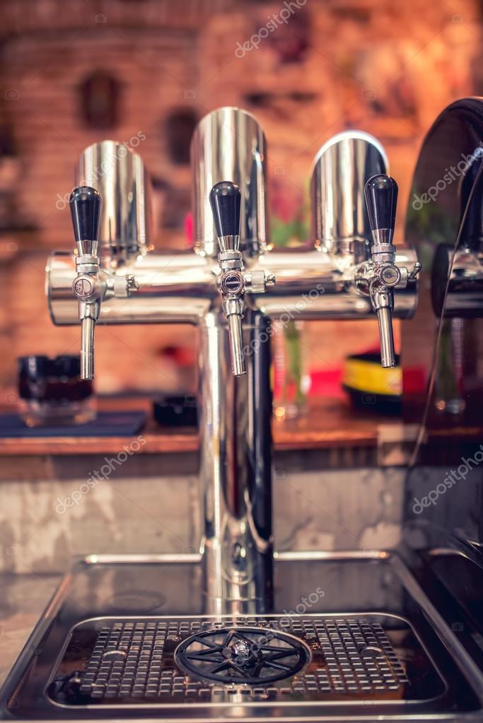 Beer taps at restaurant, bar, pub or bistro. Close-up details of beer ...