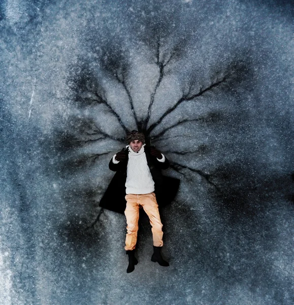 Man laying on ice in winter Stock Photo by ©xload 105640926