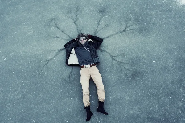 Man laying on ice in winter Stock Photo by ©xload 105640926