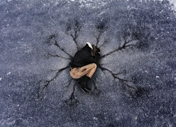 Man laying on ice in winter Stock Photo by ©xload 105640926