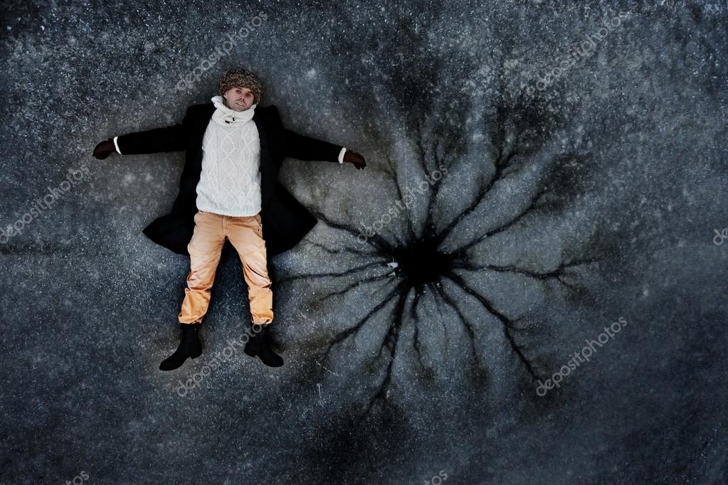 Man laying on ice in winter Stock Photo by ©xload 105640926