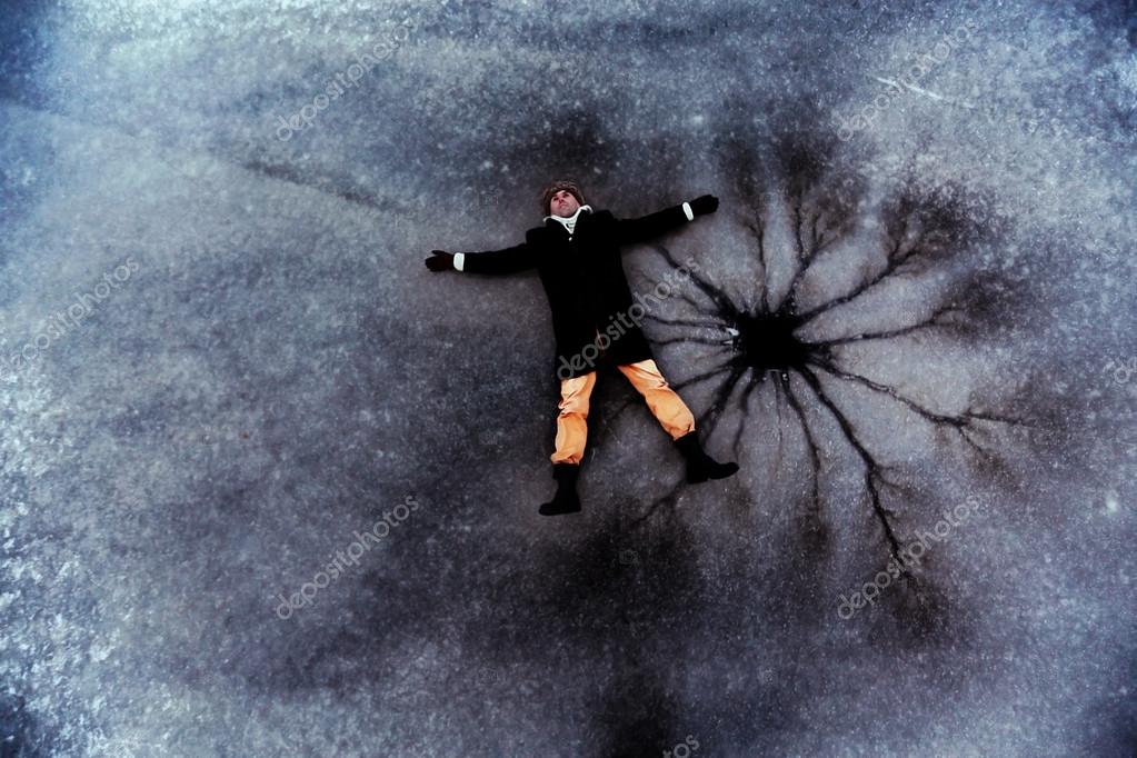 Stressed man laying on ice in winter Stock Photo by ©xload 105640940