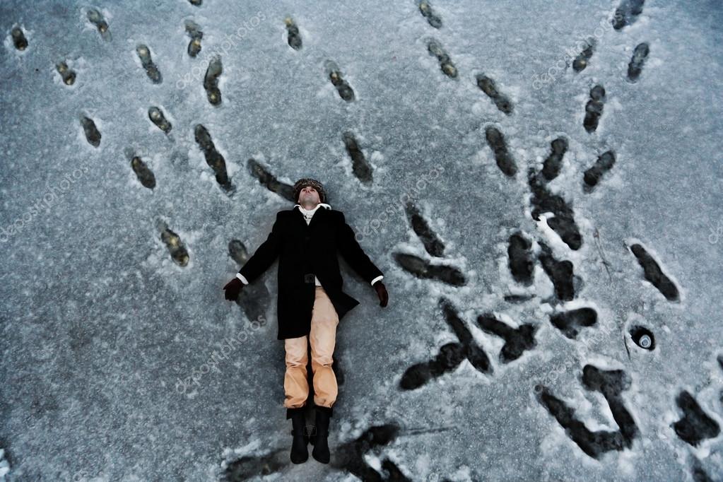 Stressed man laying on ice in winter Stock Photo by ©xload 105640972