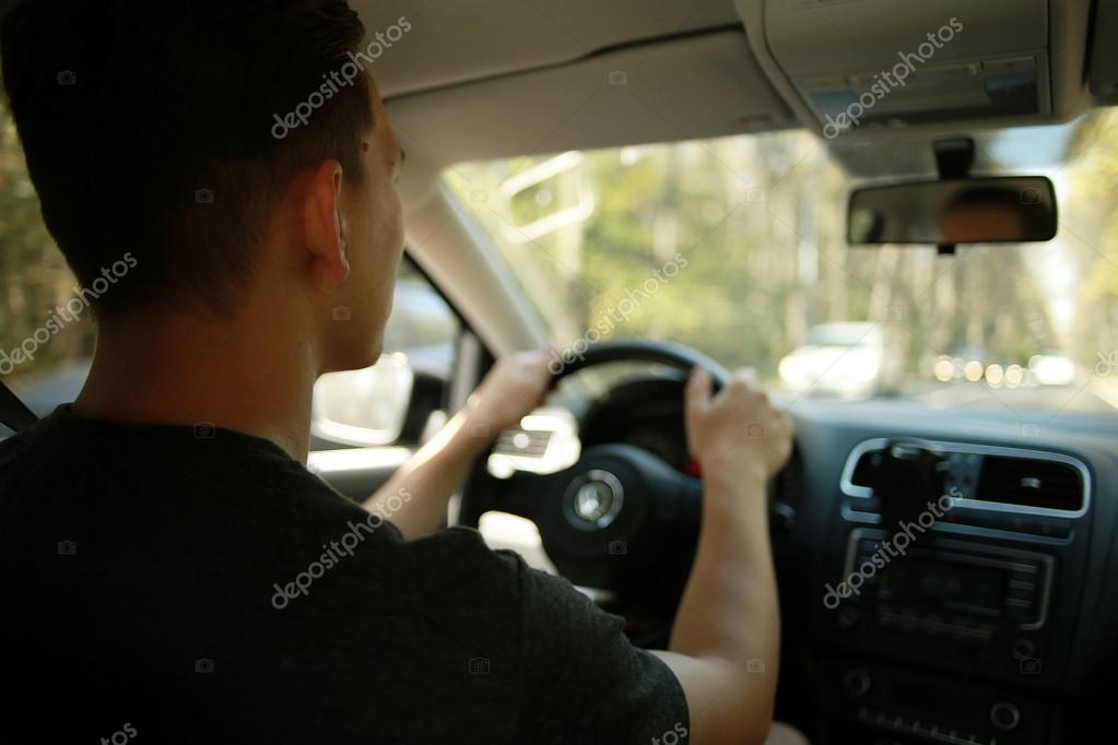 Young man driving a car Stock Photo by ©xload 105642530