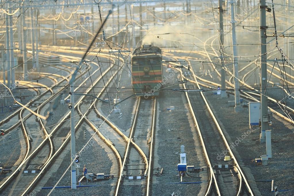 Railroad rails with train Stock Photo by ©xload 55343011