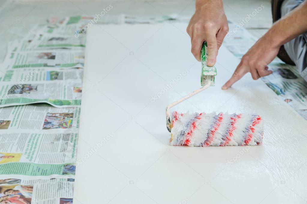 Worker pasting wallpapers. Stock Photo by ©Yunava1 123845182