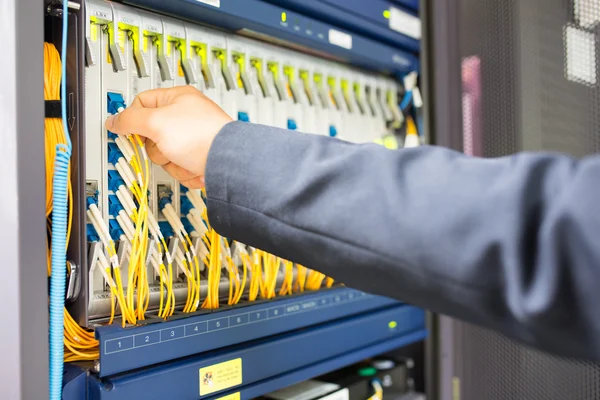 People fix core switch in network room - Stock Image - Everypixel