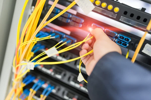 People fix core switch in network room - Stock Image - Everypixel