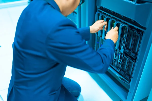 Man fix server network in data center room - Stock Image - Everypixel