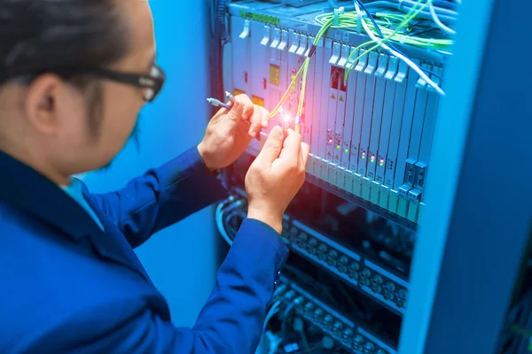 People fix core switch in network room - Stock Image - Everypixel