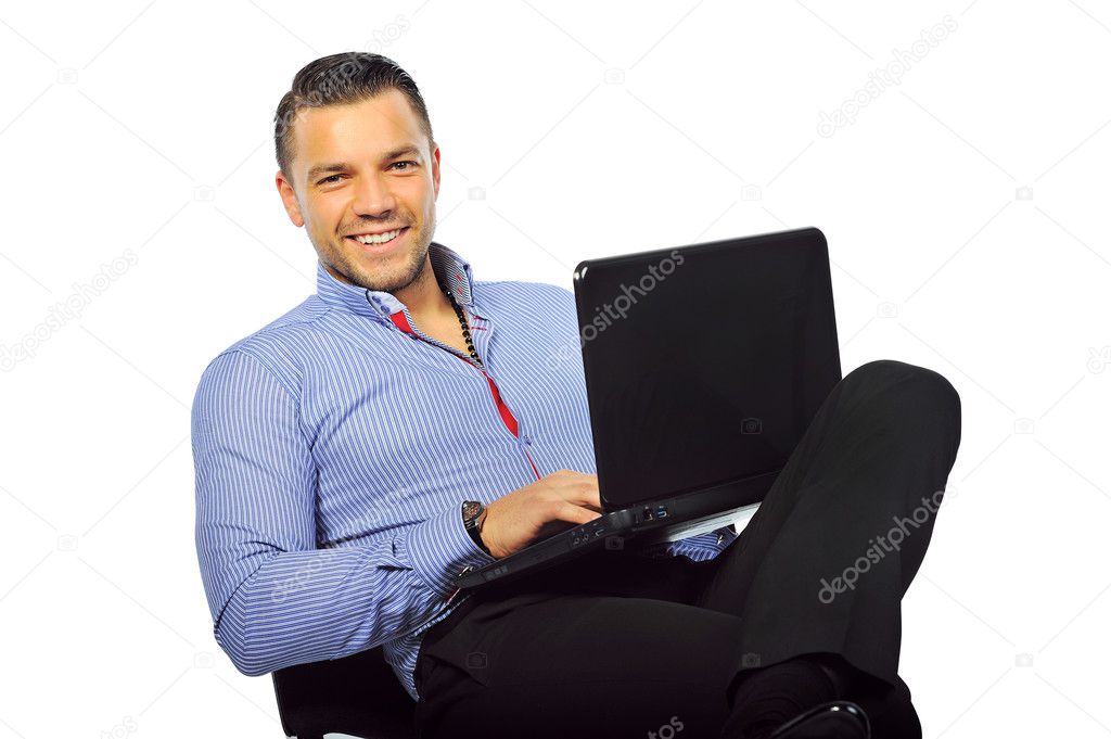Happy smiling young man sitting at studio with laptop computer i Stock ...
