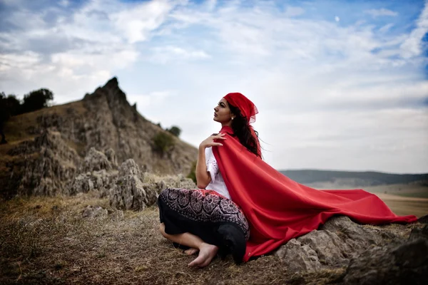 Beautiful woman with red cloak Stock Photo by ©bereta 57248423