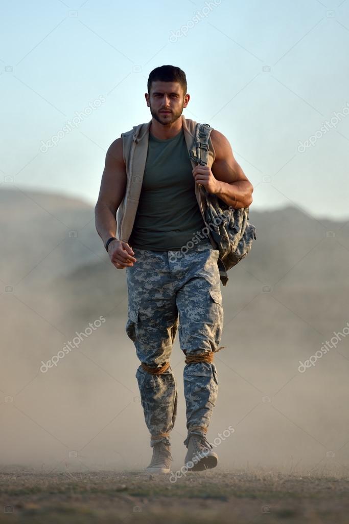 Athletic young man on dusty field — Stock Photo © bereta #71940799