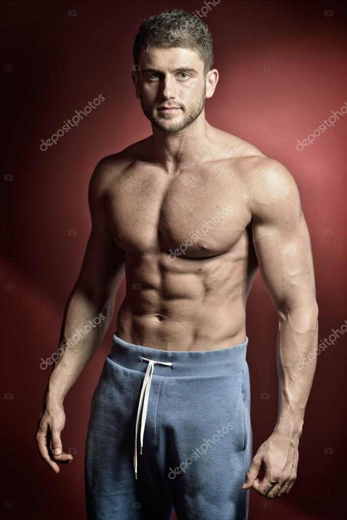 Athletic young man portrait in studio with dark background Stock Photo ...