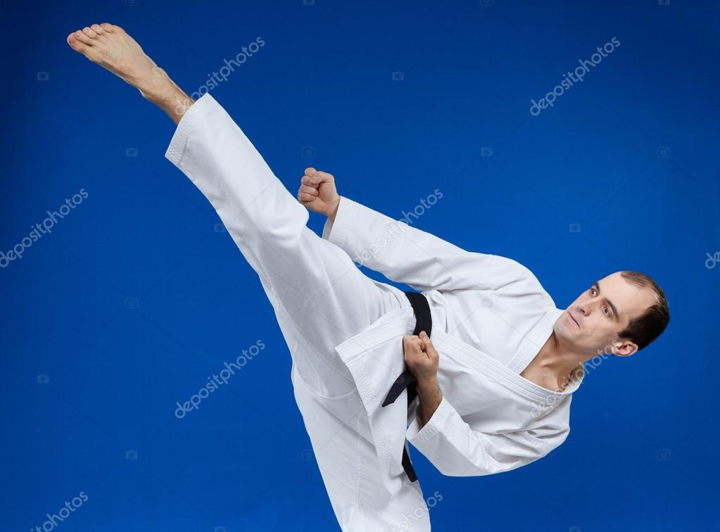 Roundhouse kick making the athlete Stock Photo by ©Andreyfire 98026082
