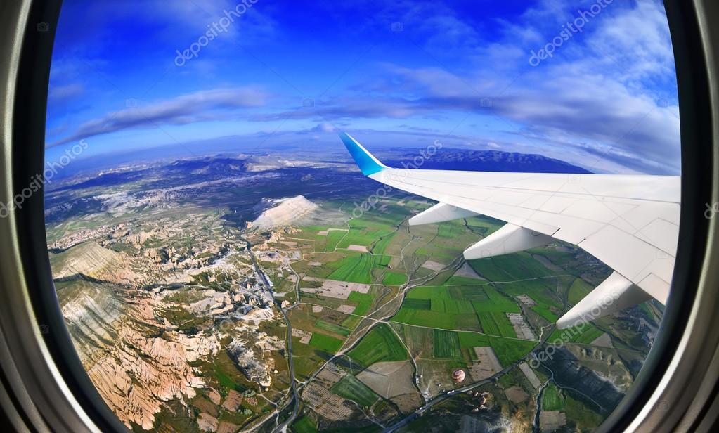 View from airplane window on fields and mountains Stock Photo by ...