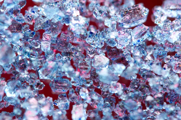 Blue crystals on a red background. Macro - Stock Image - Everypixel