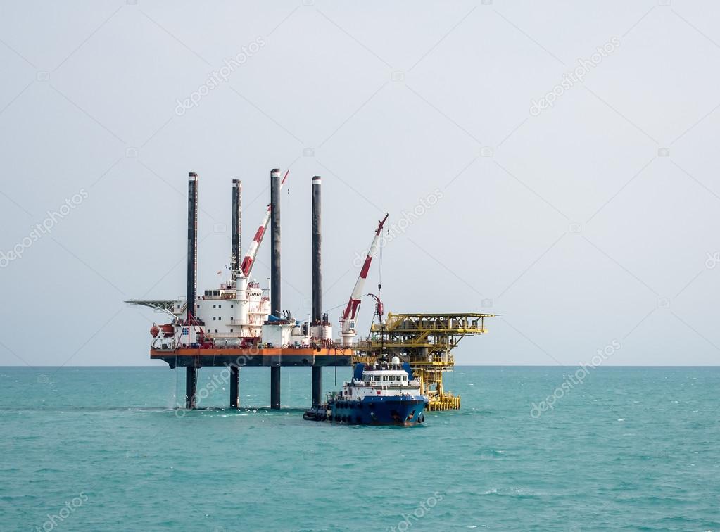 Self-elevating jack-up barge and offshore support vessel around the ...