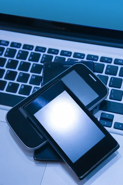 Mobile phone on a computer keyboard — Stock Photo © daboost #5011095