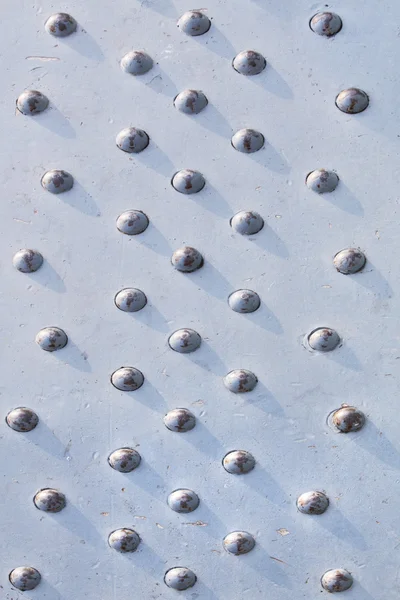 Riveted metal surface — Stock Photo © MADDRAT #51877979