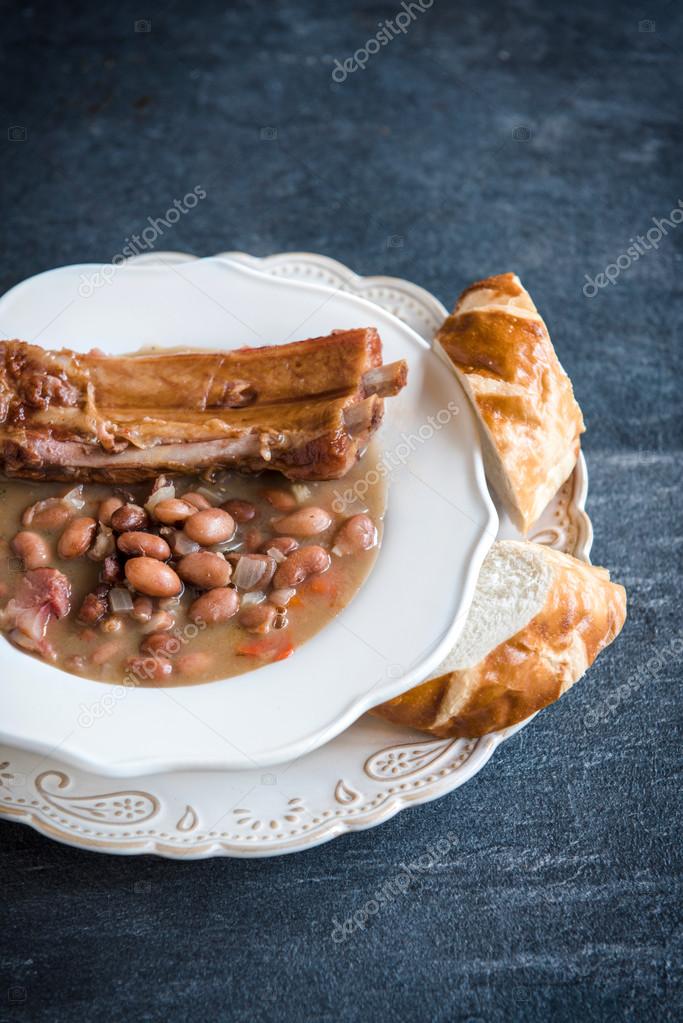 Served cooked beans with ribs in bowl Stock Photo by ©uroszunic 82871386
