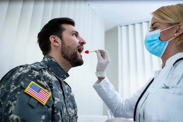 Testing military on corona virus. American soldier in uniform doing PCR ...