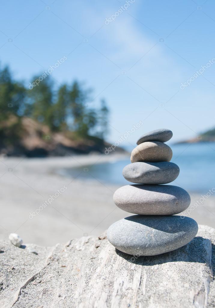 Stone pyramid, stacking five stones, beach Stock Photo by ©nadik29 79847816
