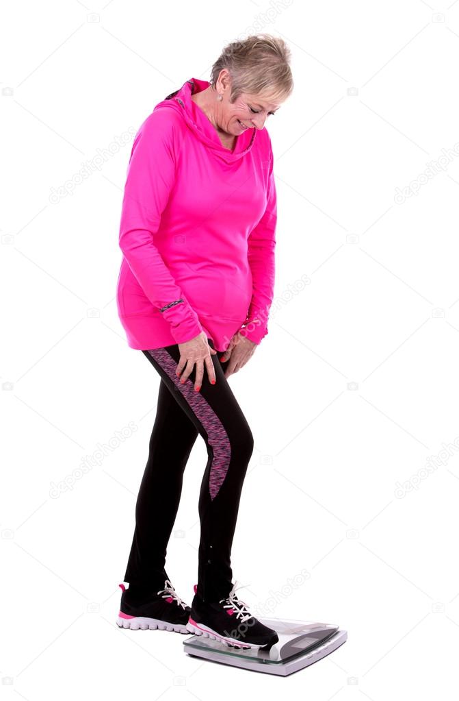 Fit woman stepping on scale Stock Photo by ©zdenkam 98930502