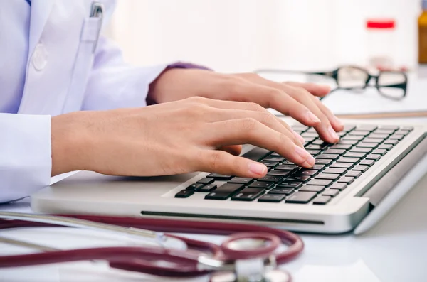 Doctor typing on computer - Stock Image - Everypixel