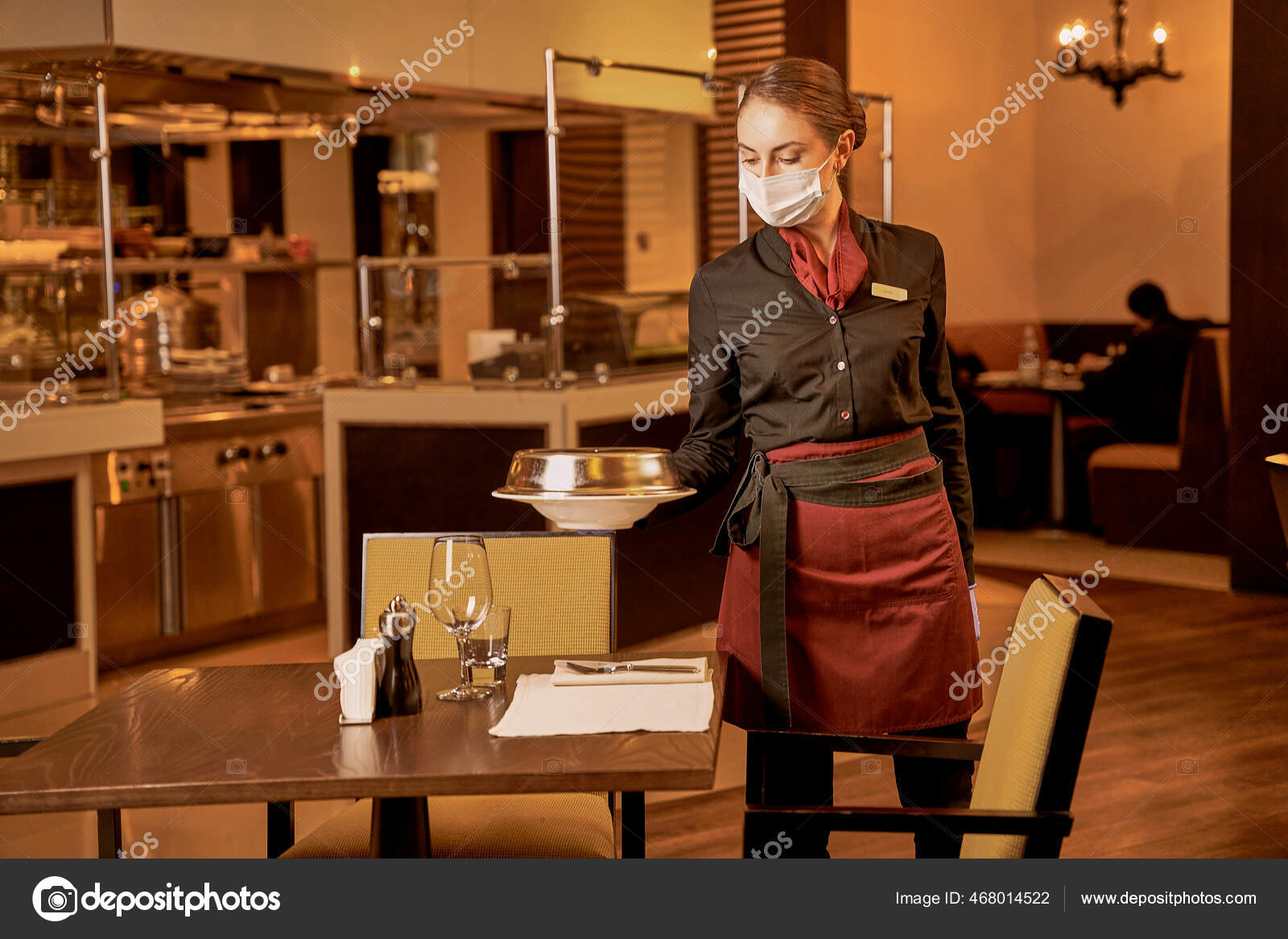 Waitress putting a restaurant meal on a prepared table Stock Photo by ...