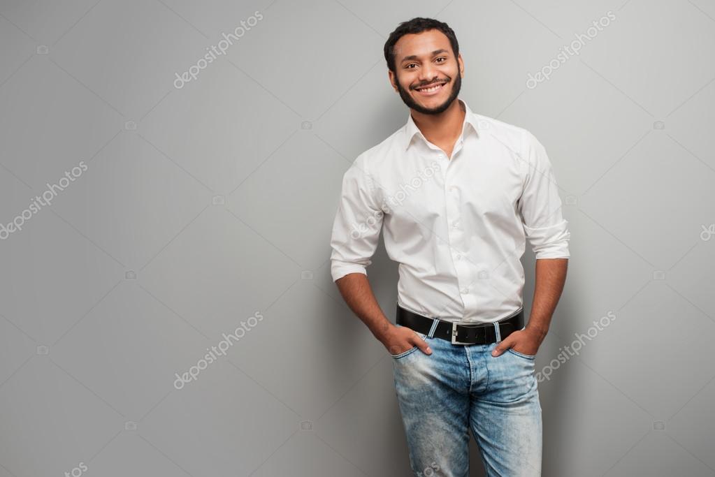 Mixed race man standing on grey background ⬇ Stock Photo, Image by ...