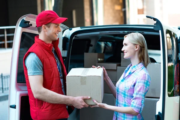 First class delivery service. Courier Delivering Package By Van. Stock ...