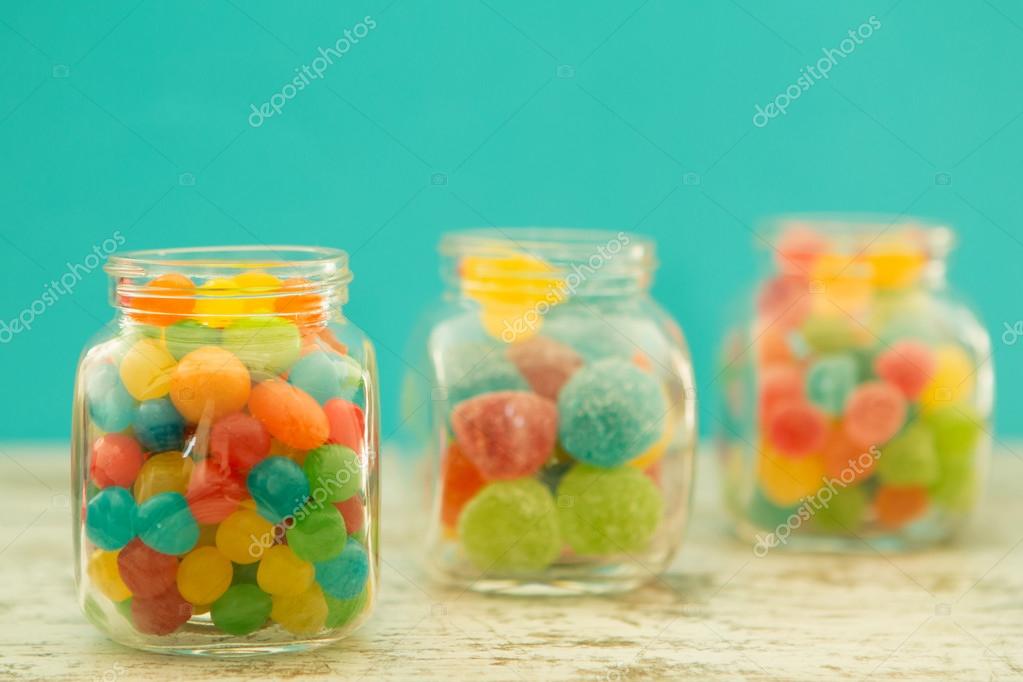 Three glass jars full of jellybeans with blue background Stock Photo by ...