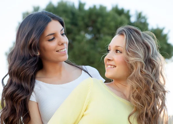 Two girls smiling at camera - Stock Image - Everypixel