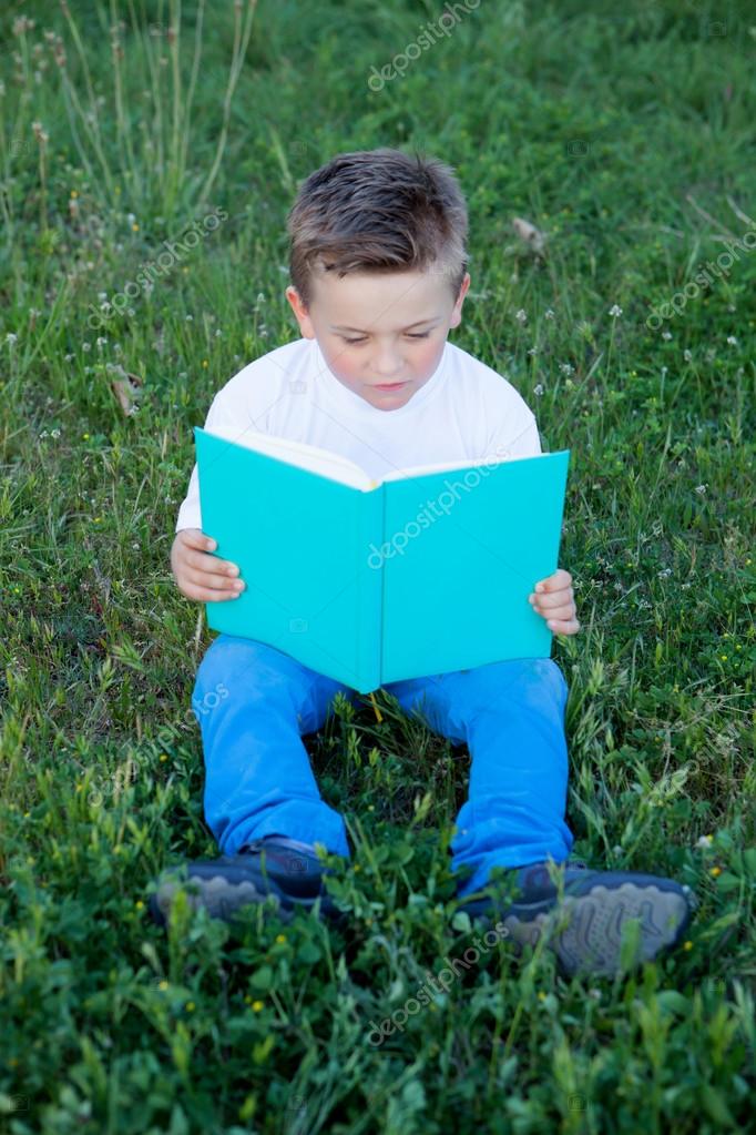 Little kid reading a book at outside — Stock Photo © Gelpi #73002789
