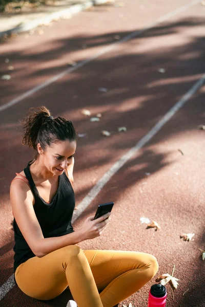 Athletic woman working out on running track - Stock Image - Everypixel