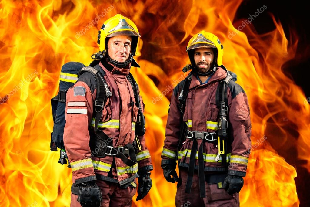 Firemen against burning background. — Stock Photo © karelnoppe #62185797