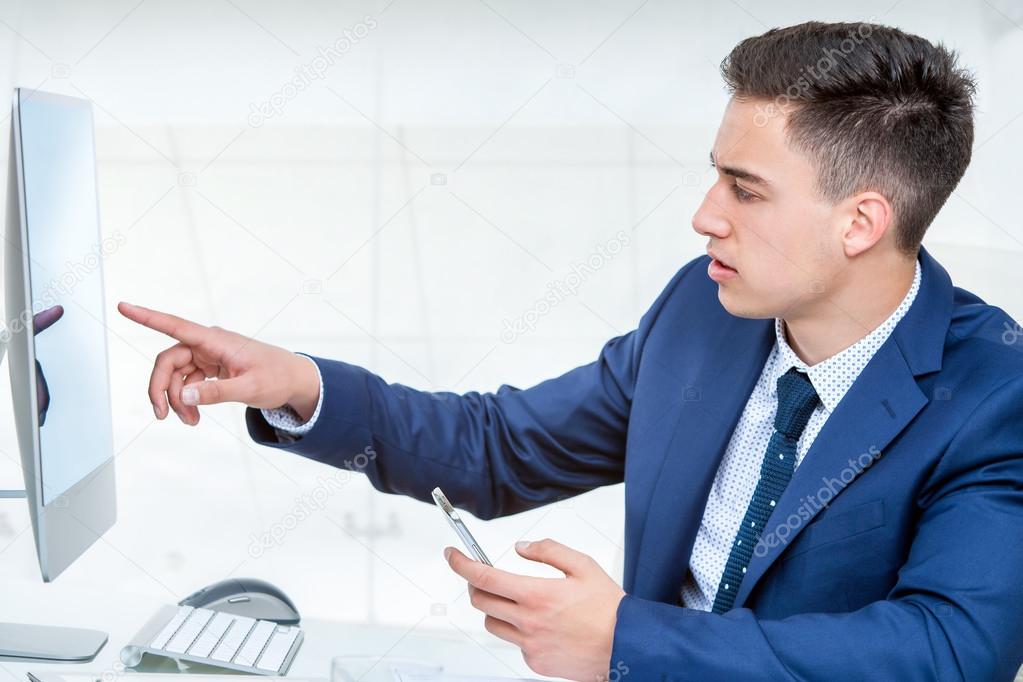 Businessman pointing at blank computer screen. Stock Photo by ...