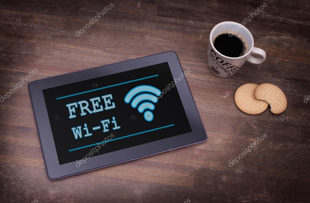 Tablet with Wi-Fi connection on a wooden desk — Stock Photo ...