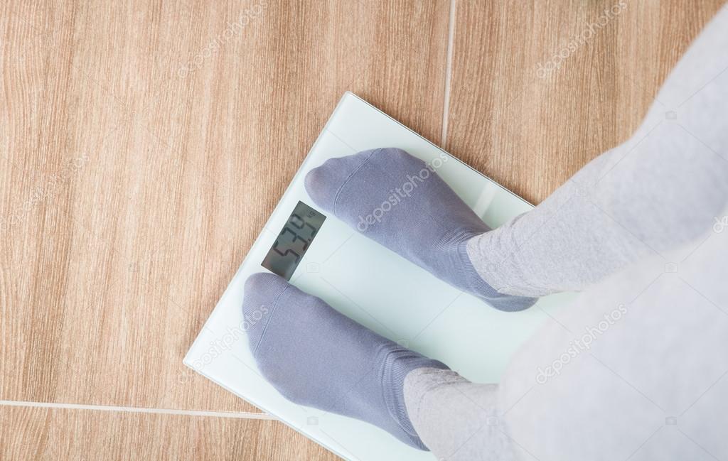 Woman standing on the scales and measuring Stock Photo by ©zestmarina ...