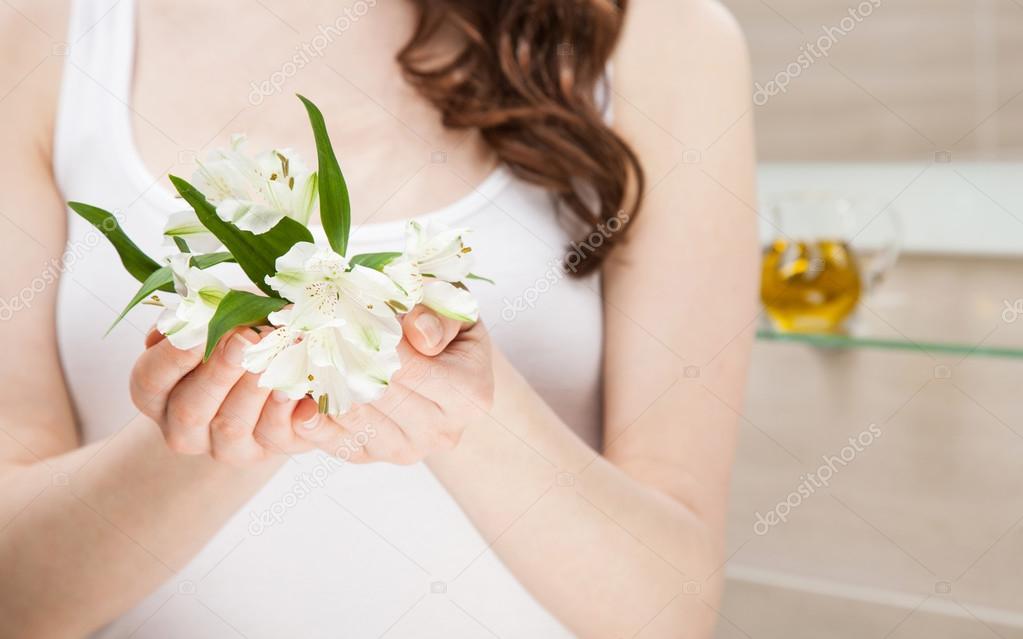 Female hands holding fresh flowers Stock Photo by ©zestmarina 109621444