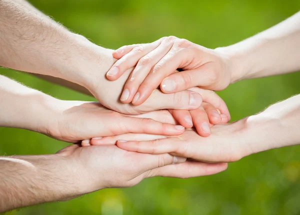 Hands together on background Stock Photo by ©aletia 105598060