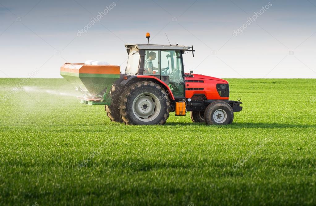 Tractor fertilizing in field — Stock Photo © fotokostic #100282274
